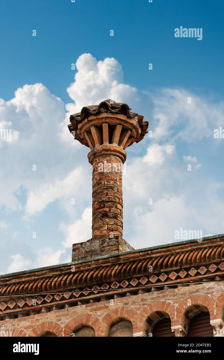 Close-up of an ancient chimney made of a bricks on a blue sky with ...