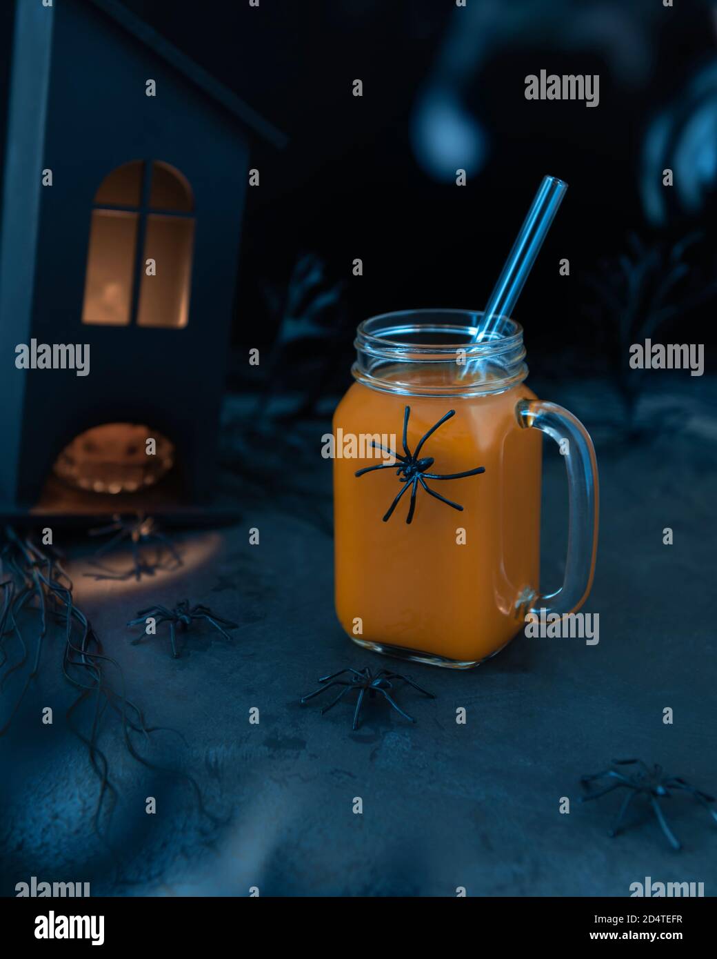 Halloween scary still life with pumpkin mocktail, spiders, spooky black ...