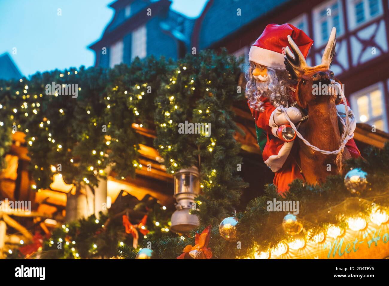Low angle shot of illuminated Christmas decorations with Santa Claus in ...