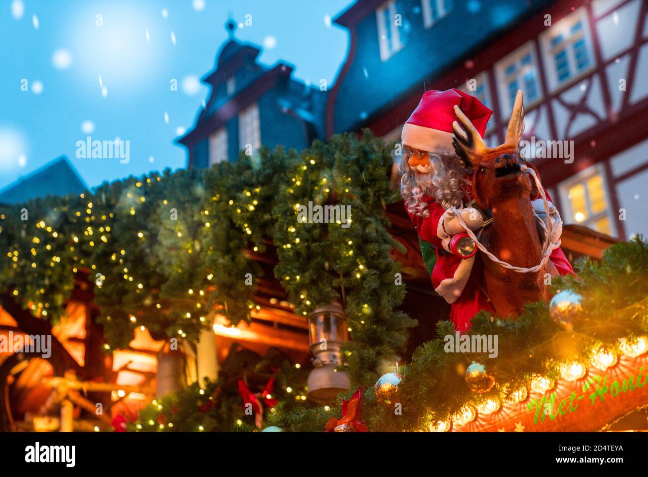 Low angle shot of illuminated Christmas decorations with Santa Claus in ...