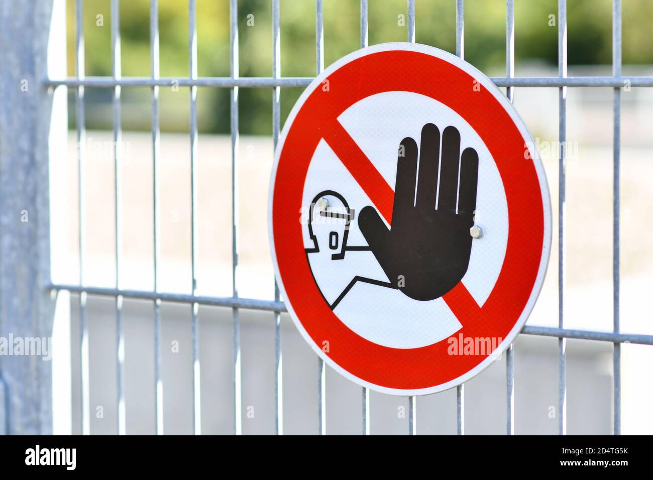 Round 'Keep out' warning sign with person holding up hand in red circle ...