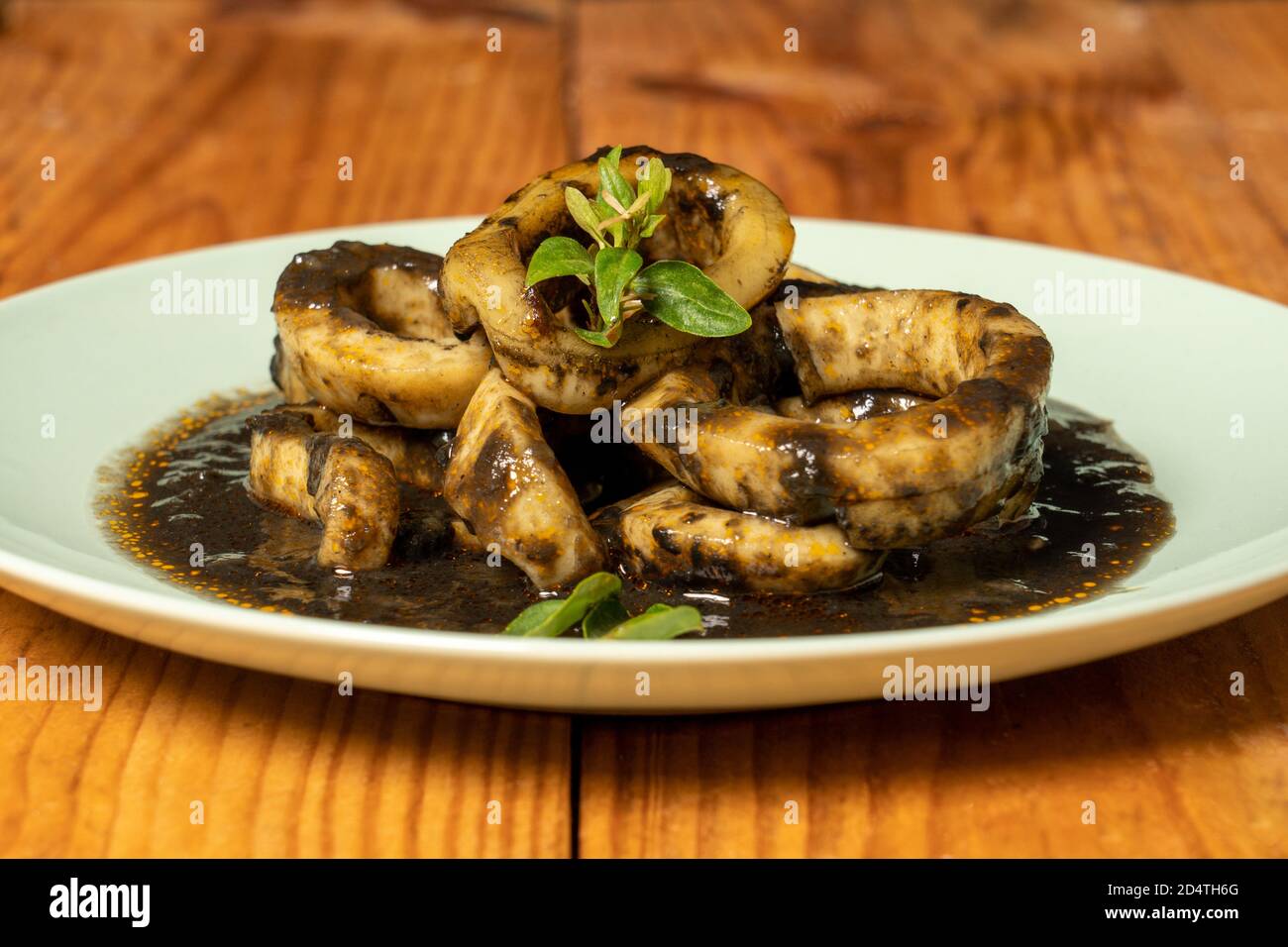 Closeup shot of delicious calamari prepared with ink and sauces Stock ...