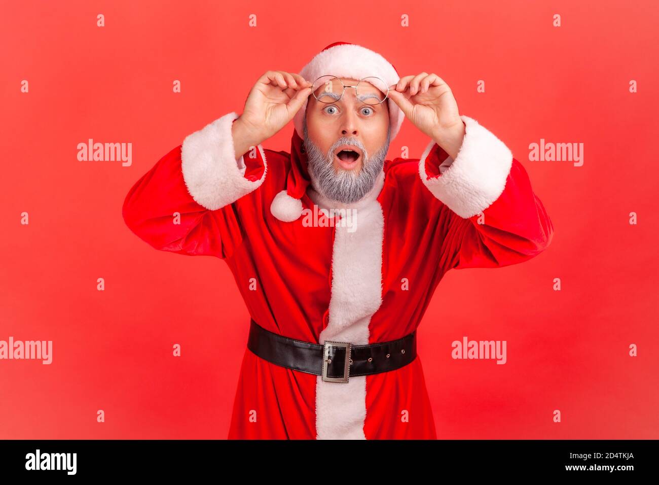 Portrait of extremely shocked surprised santa claus looking at camera ...