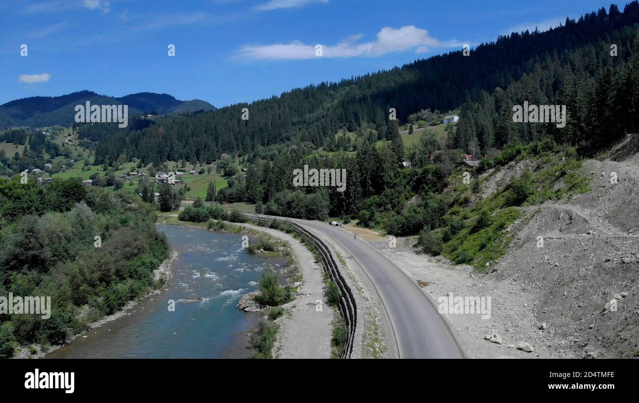 Clear fresh river beside a thin asphalt road Stock Photo - Alamy