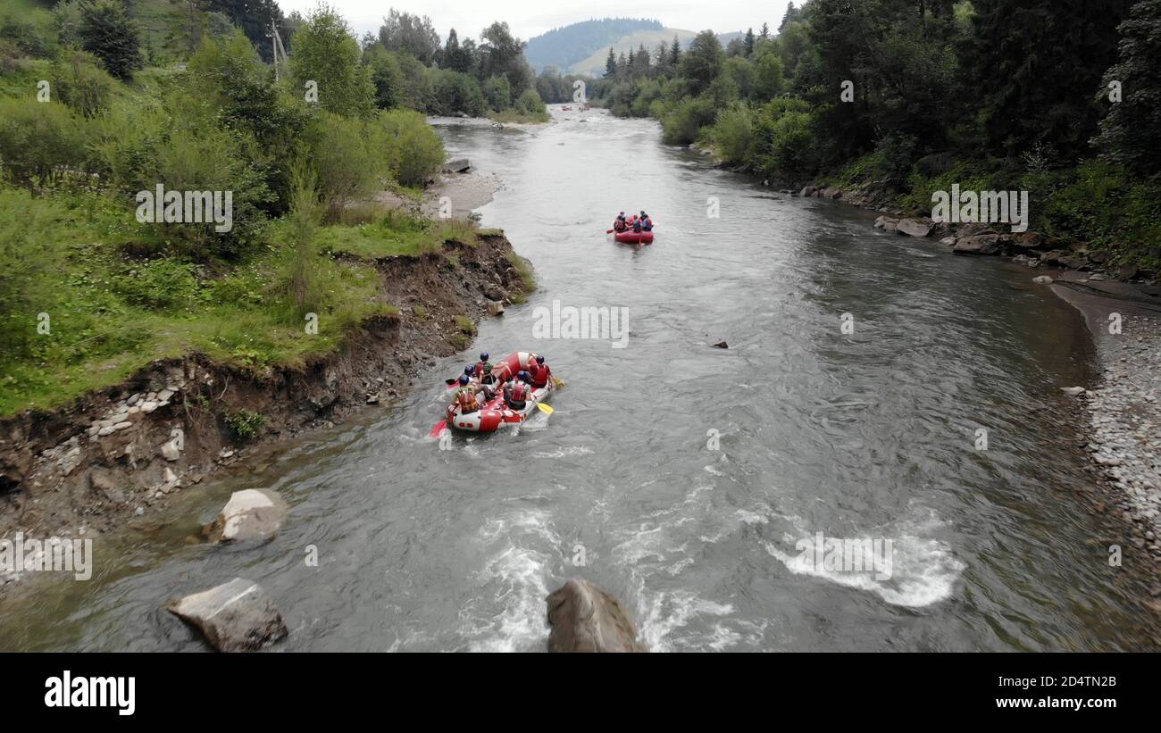 Several people team are rafting in a calm water Stock Photo - Alamy