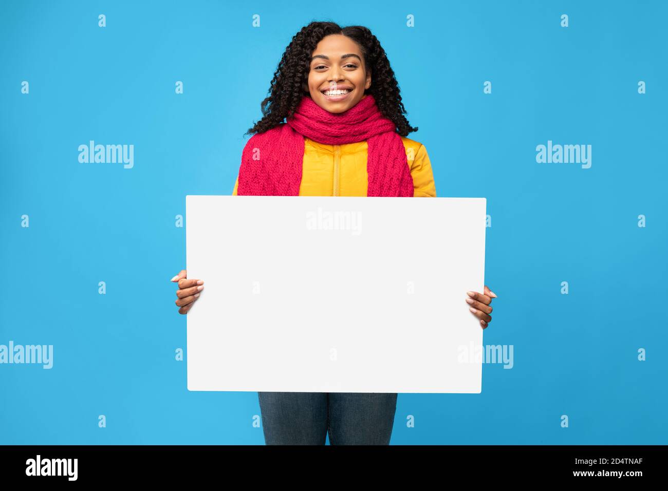 Happy Black Woman Holding Empty Paper Board On Blue Background Stock ...