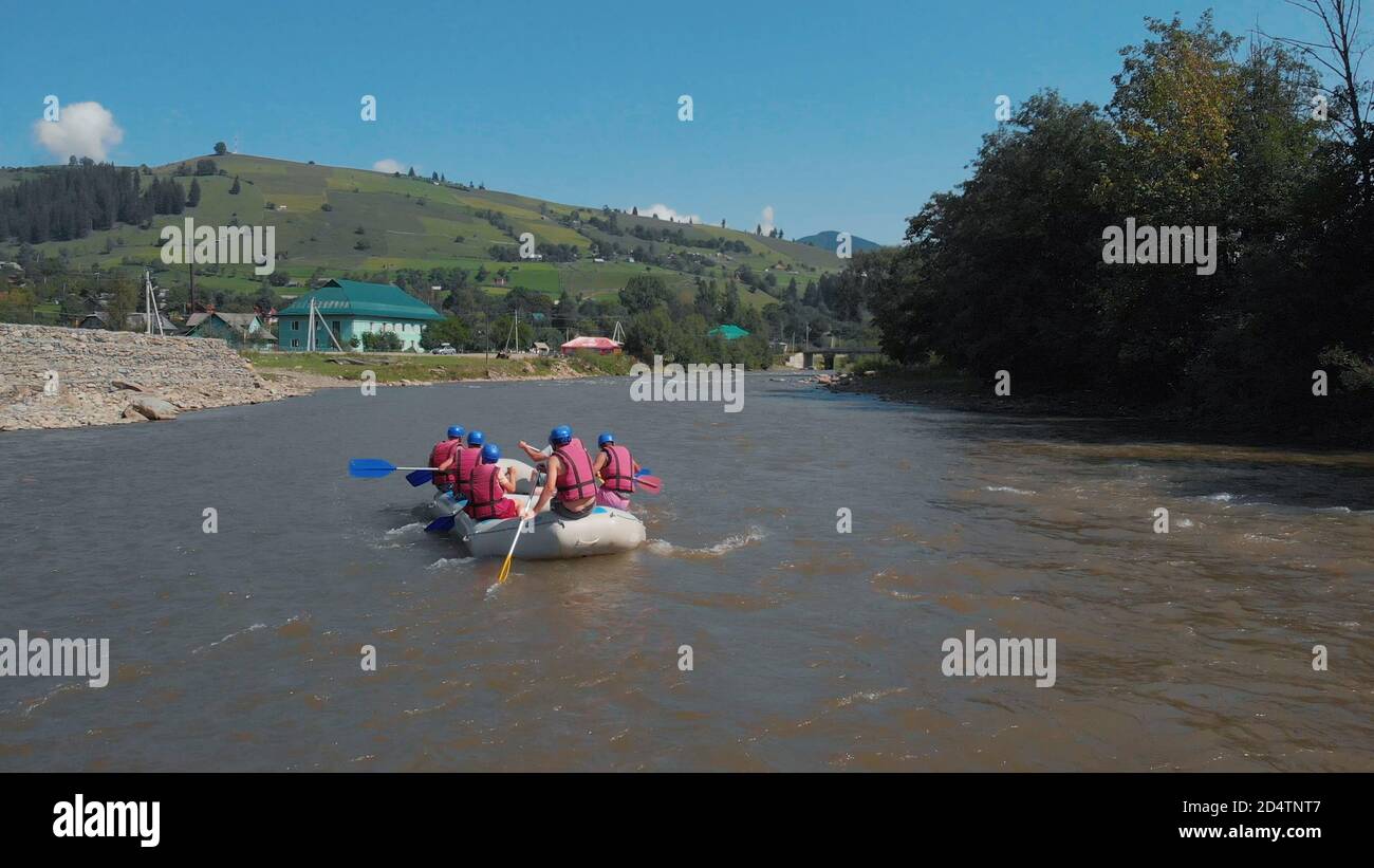 Several people team are rafting in a calm water Stock Photo - Alamy