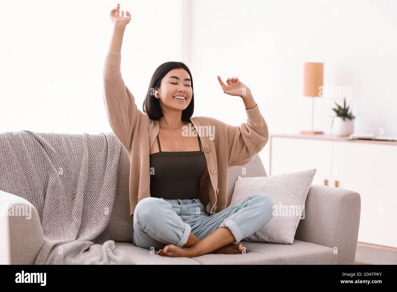 Woman dancing on couch hi-res stock photography and images - Alamy