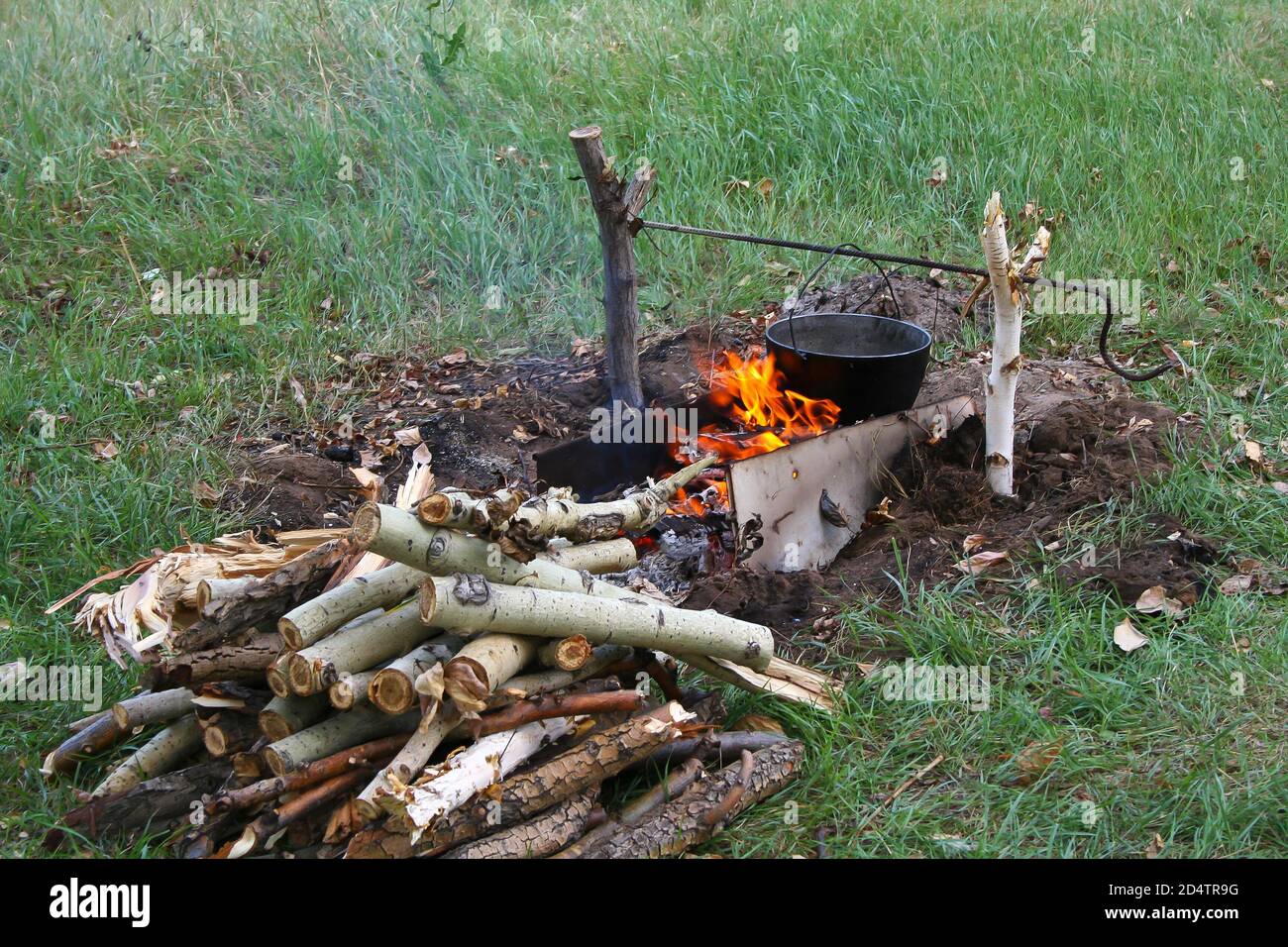 Clear shot of a pot in a metal stick above the fire on the outdoor ...