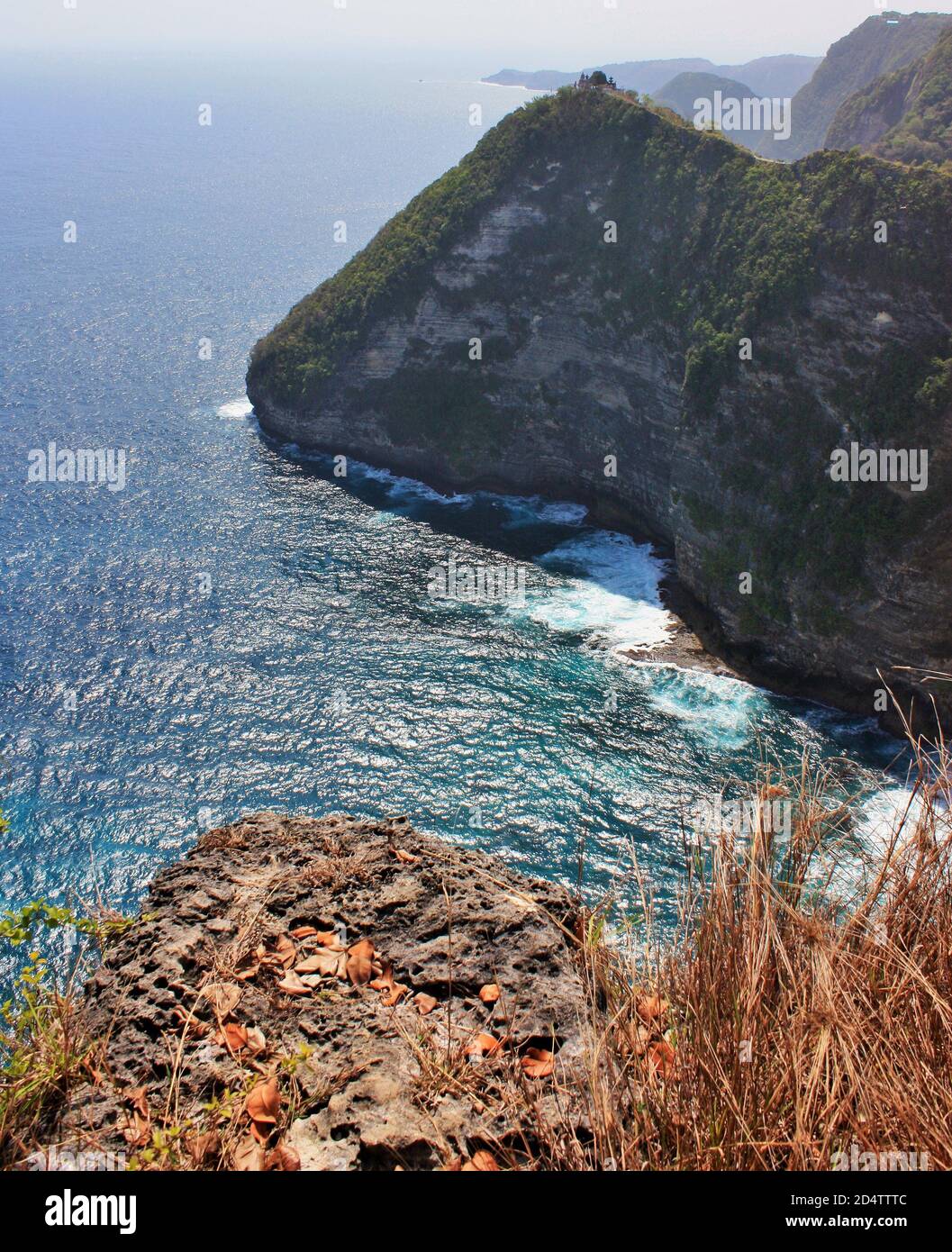Scenic view of shimmering blue ocean from the edge of a steep cliff ...