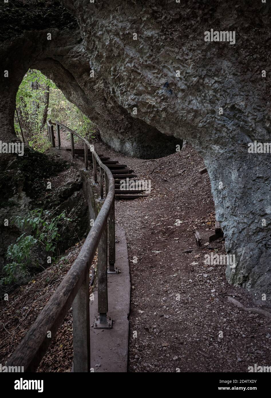 Stairway under the beautiful rocky arch cave in the park Stock Photo ...
