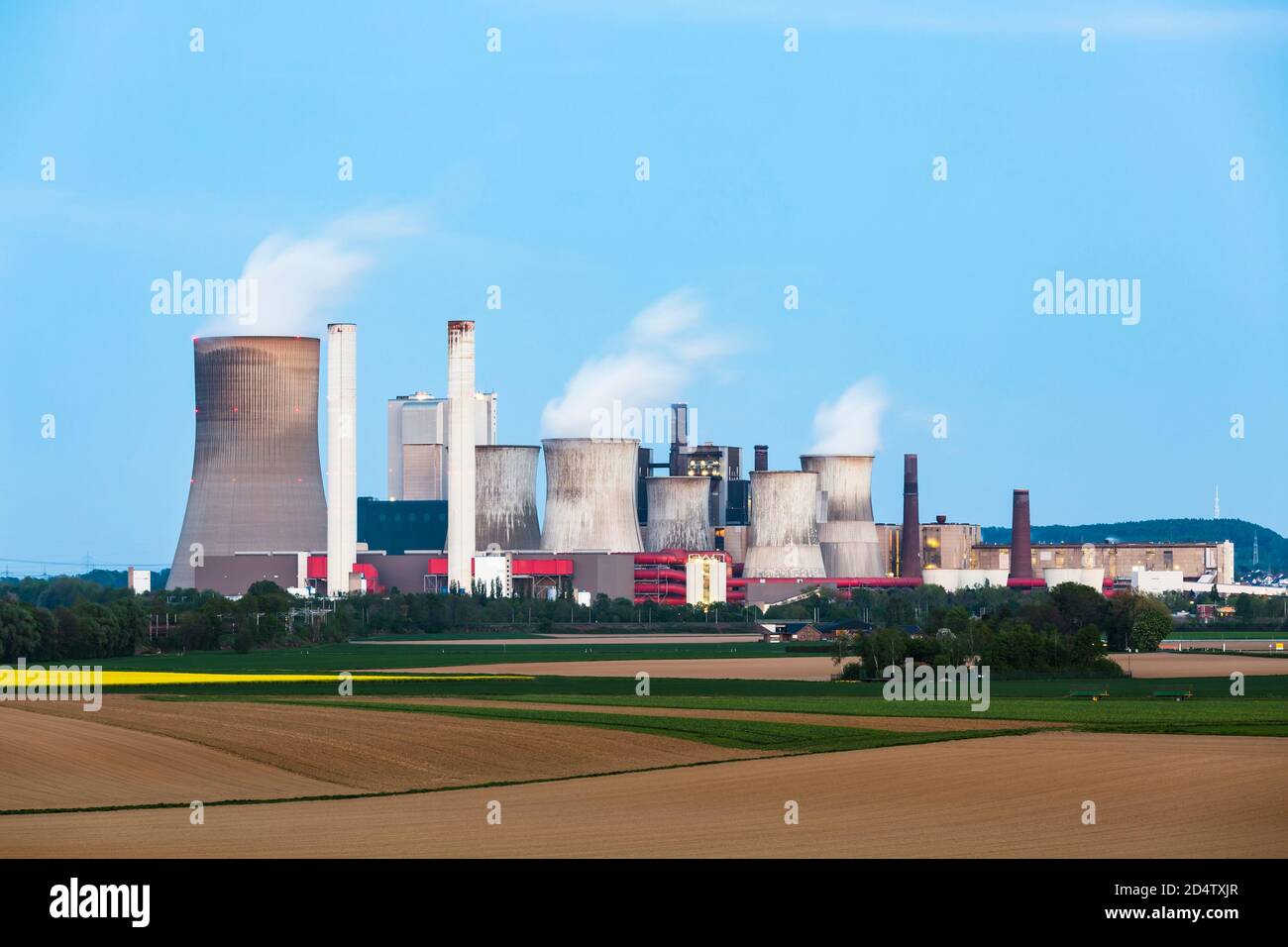 A lignite power station with night blue sky and a lot of steam. Power ...