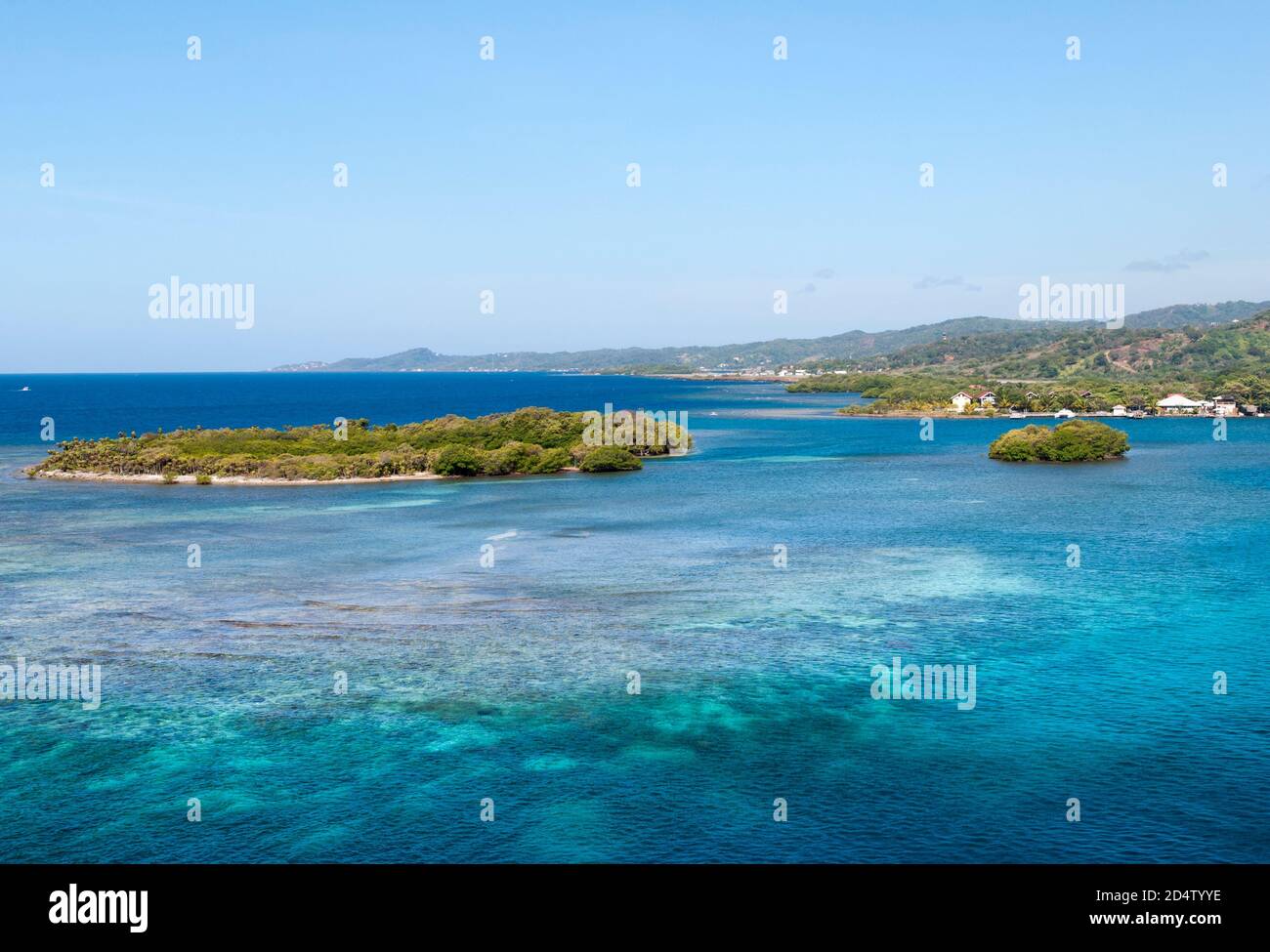 The morning view of shallow colorful waters near Roatan tourist island ...