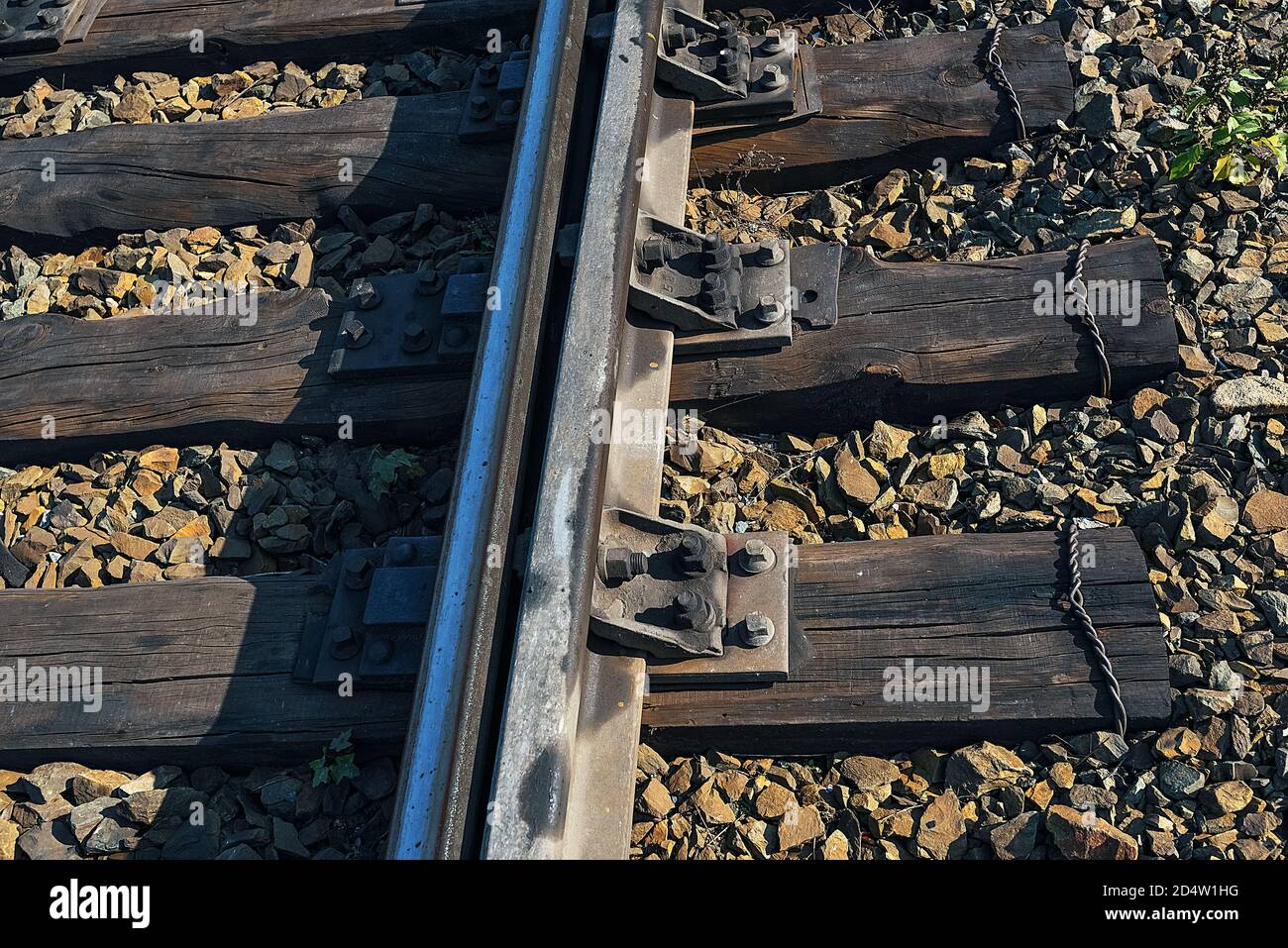 Single rail as part of a railway. Wooden sleepers and gravel are also ...