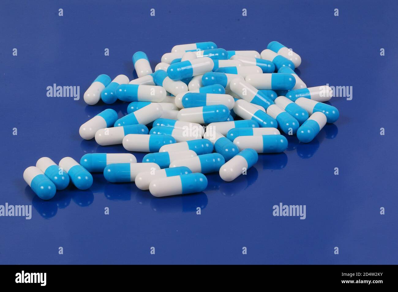 Pile of blue and white medical tablets on a blue background Stock Photo ...