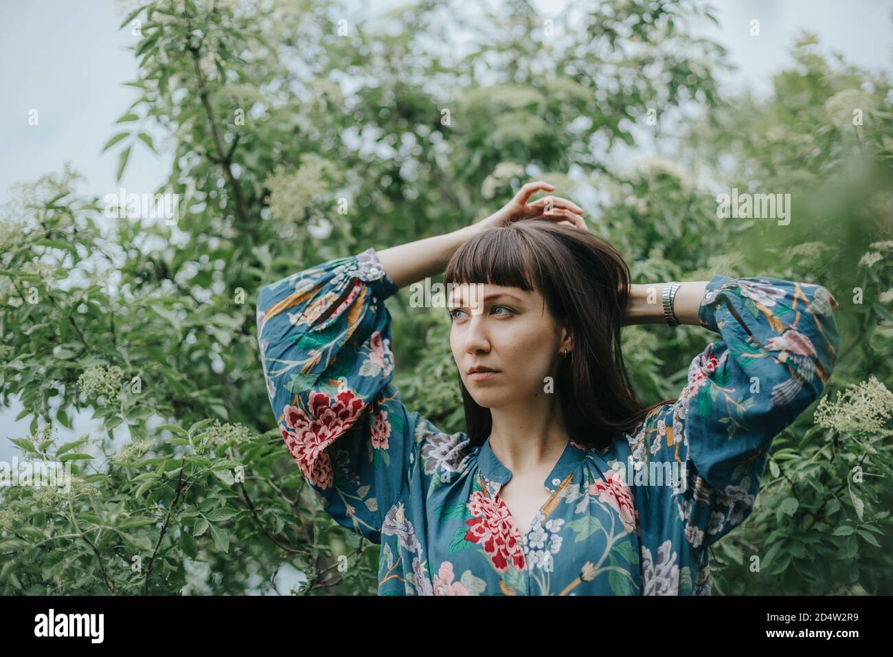 Woman fixing her hair hi-res stock photography and images - Alamy