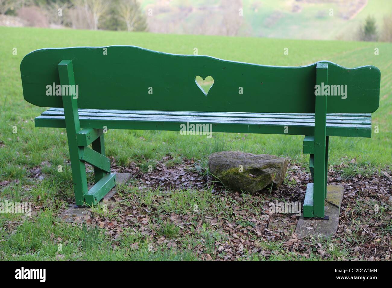 Small wooden green bench with a heart-shaped hole on it Stock Photo - Alamy