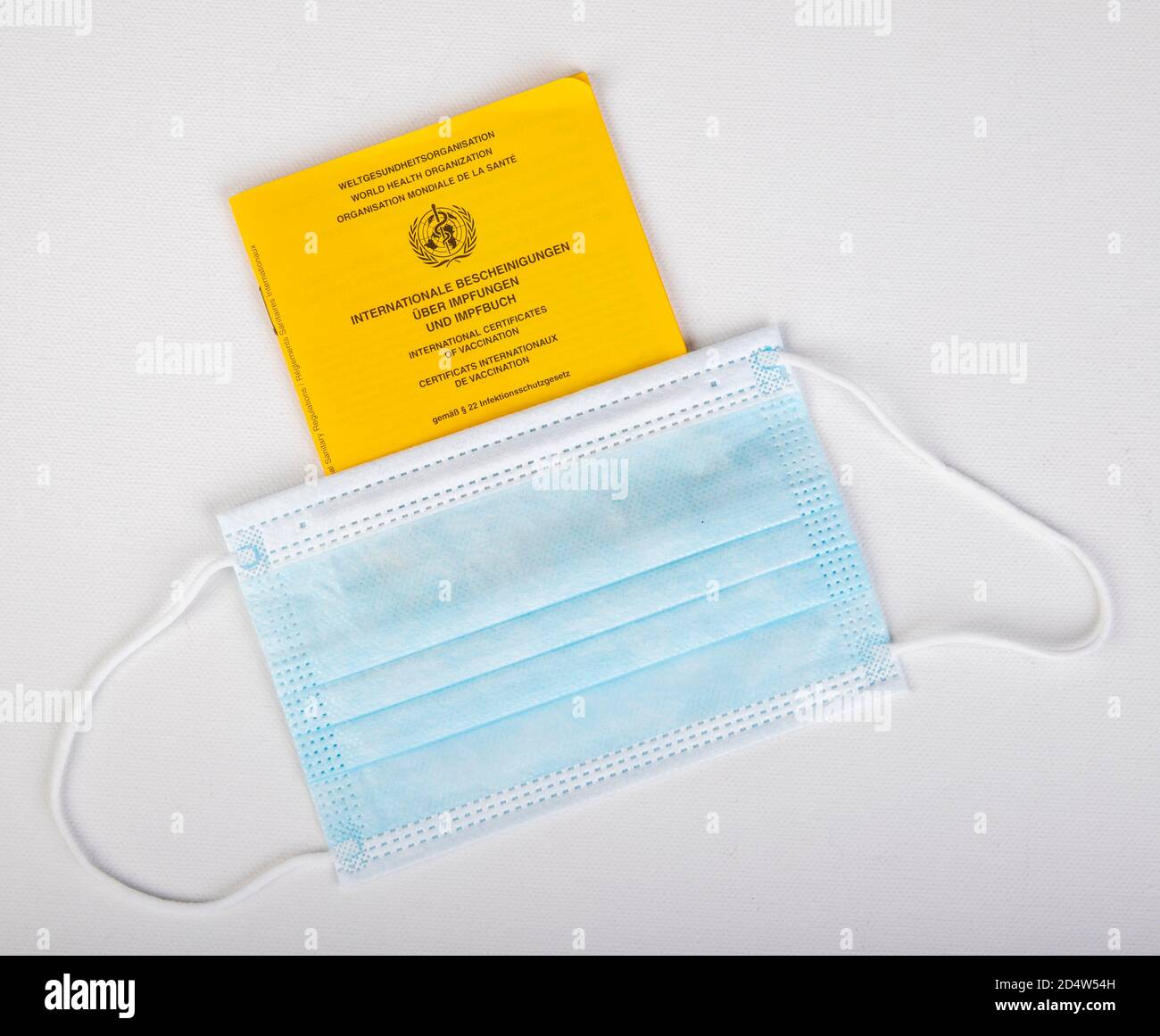 international vaccination certificate under a face mask, white ...