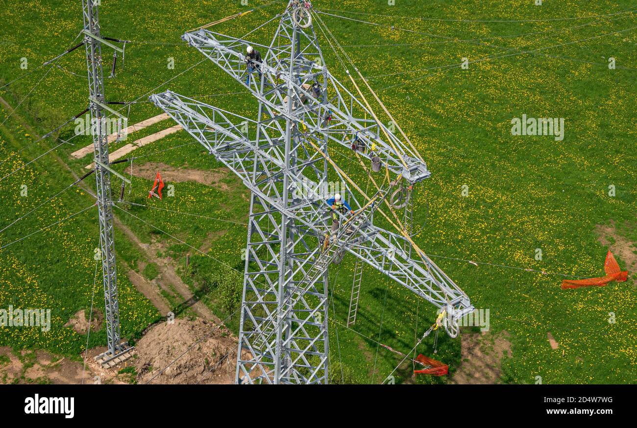 Overhead lineman & industrial climbers, working on a pylon in Bavaria ...