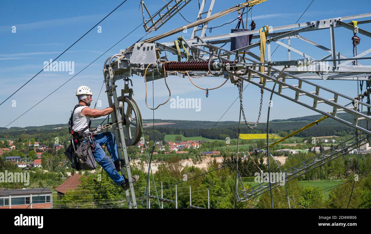 Overhead lineman & industrial climbers, working on a pylon in Bavaria ...