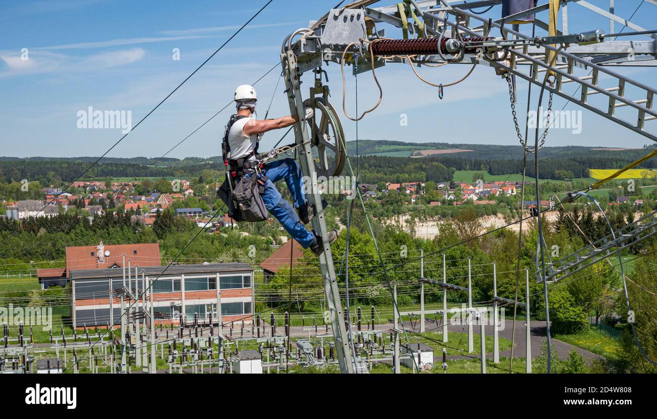 Overhead lineman & industrial climbers, working on a pylon in Bavaria ...