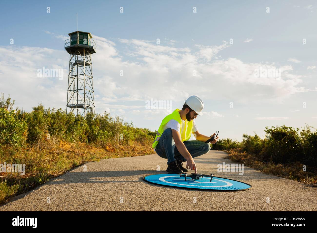 Drone operator man Launching a drone on a countryside environment Stock ...