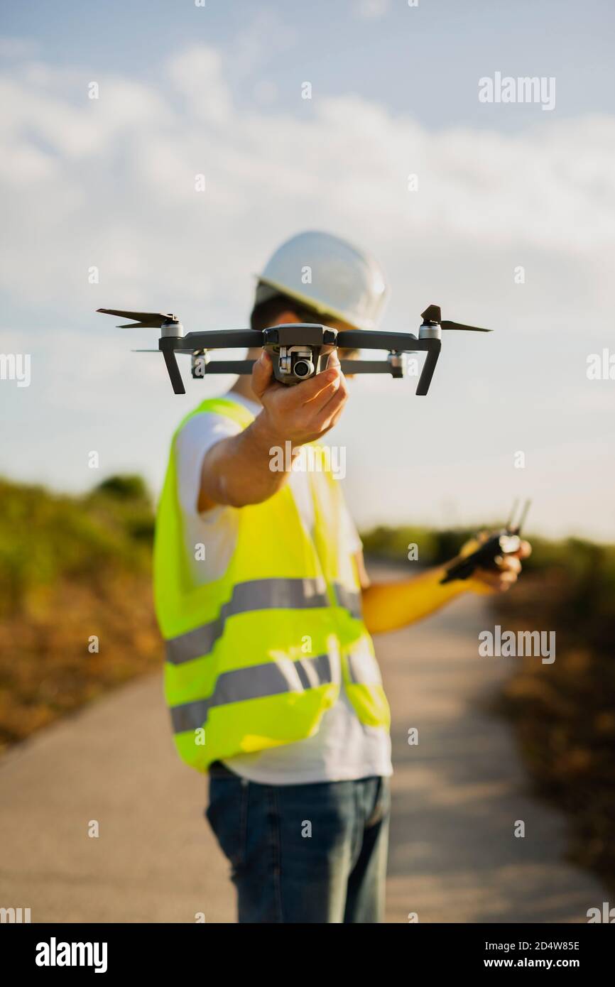 Drone operator man Launching a drone on a countryside environment Stock ...