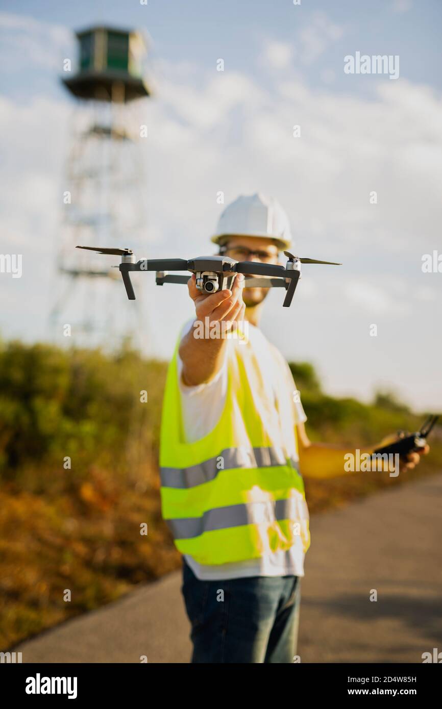 Drone operator man Launching a drone on a countryside environment Stock ...