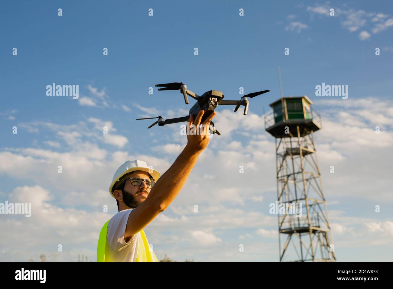 Drone operator man Launching a drone on a countryside environment Stock ...