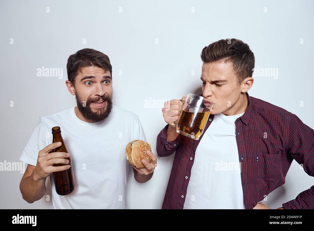 Two friends drink beer leisure fun alcohol friendship lifestyle light ...