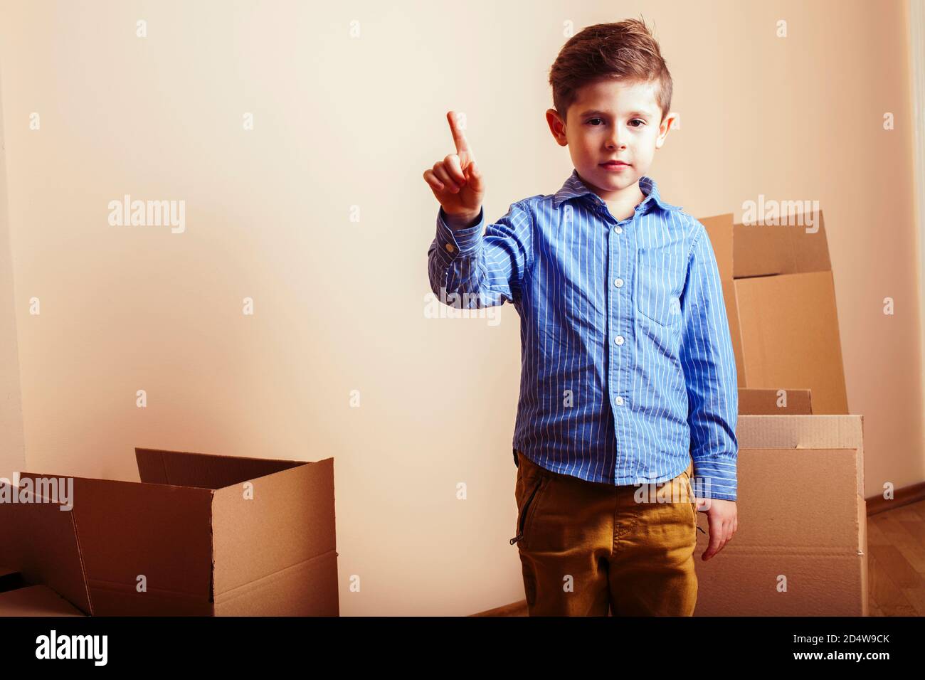 little cute boy in empty room, move to new house. home alone among ...