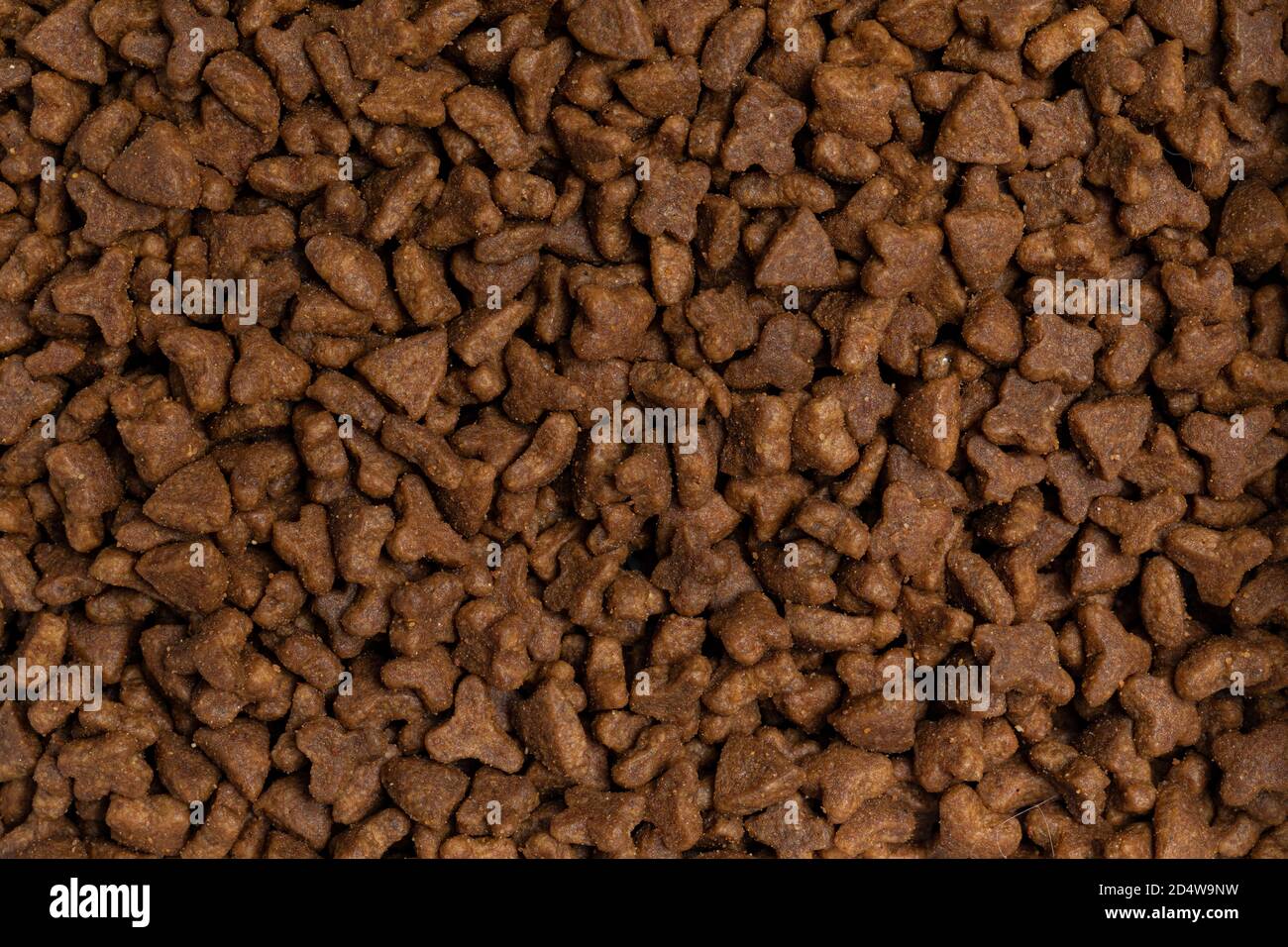 Full frame dry brown triangle pet food Stock Photo - Alamy