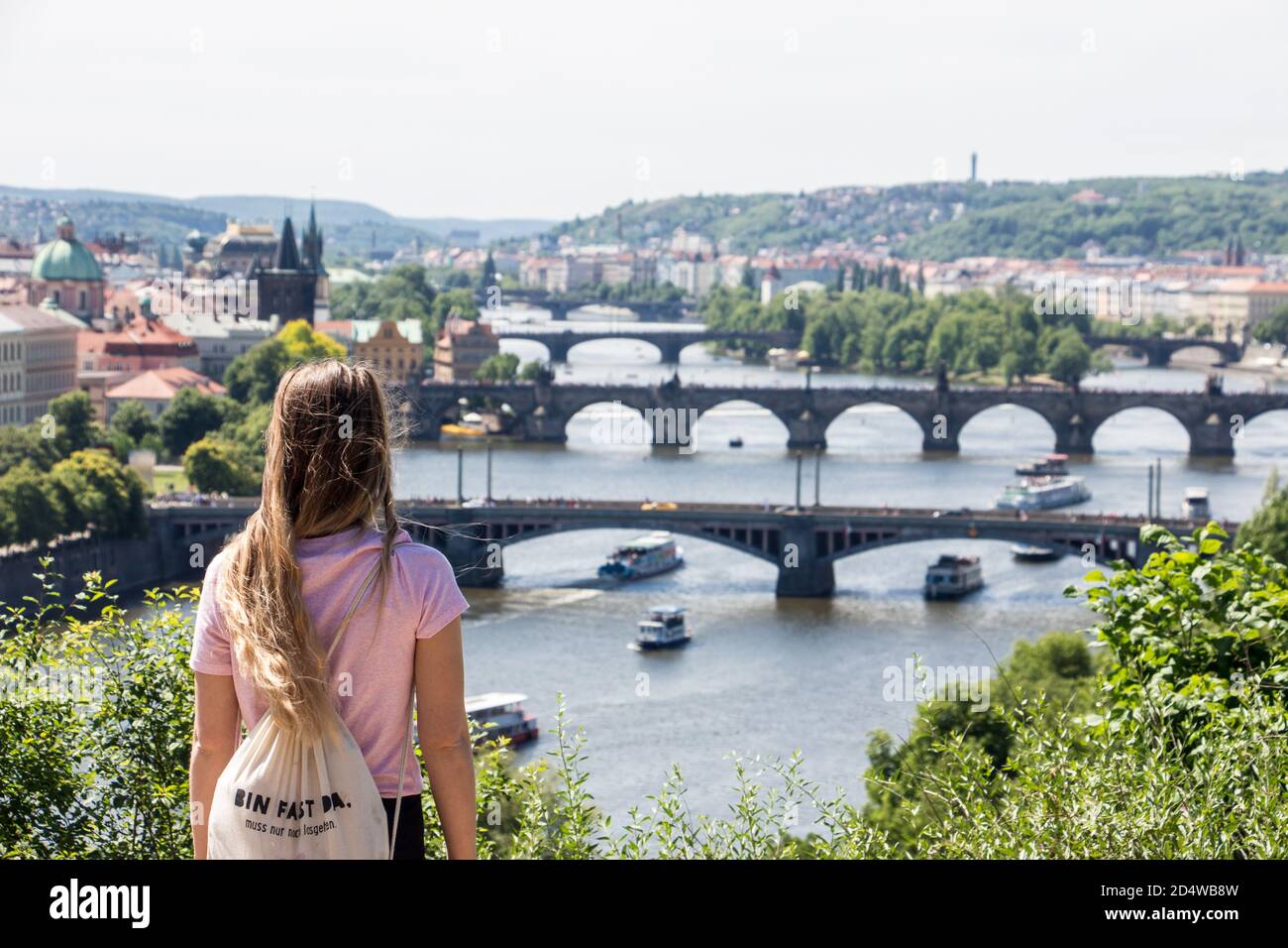 Person in front of Prague panorama charles bridge river from mountain ...