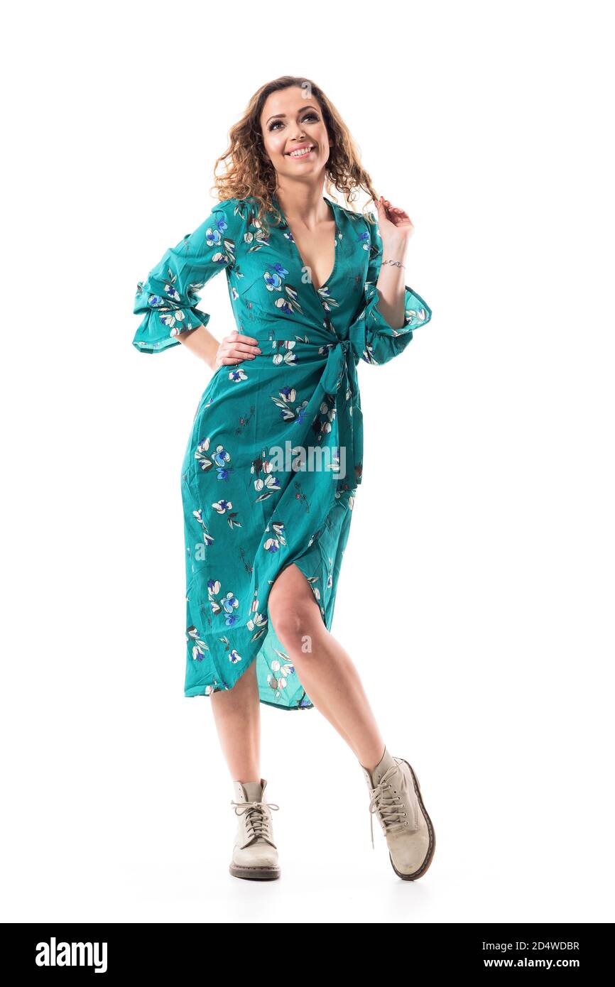 Happy smiling playful woman thinking looking up and twirling hair ...