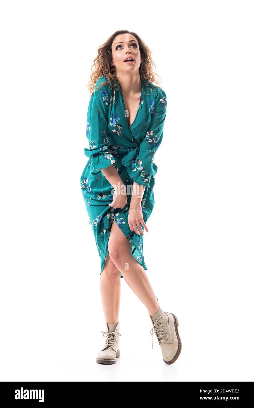 Surprised young beauty woman in dress looking up with mouth open ...