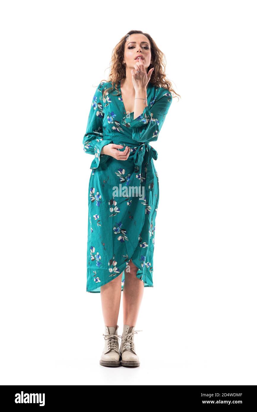 Trendy young beautiful woman applying or fixing lipstick with finger ...