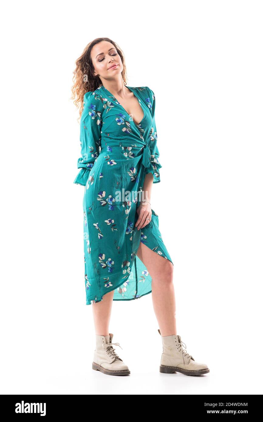 Carefree young stylish woman with closed eyes smiling in windy ...