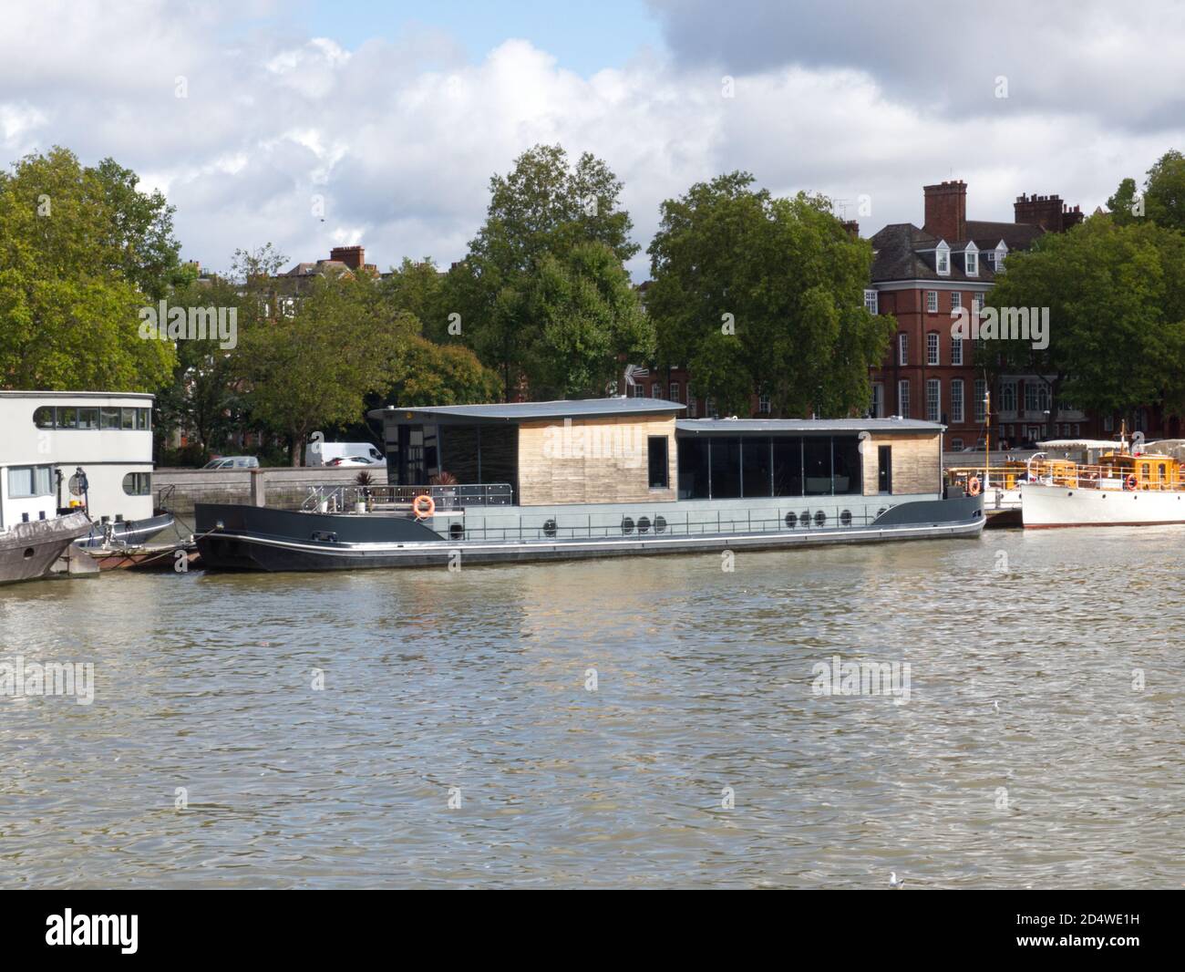 House boats moored on the River Thames in Chelsea, London. The ...