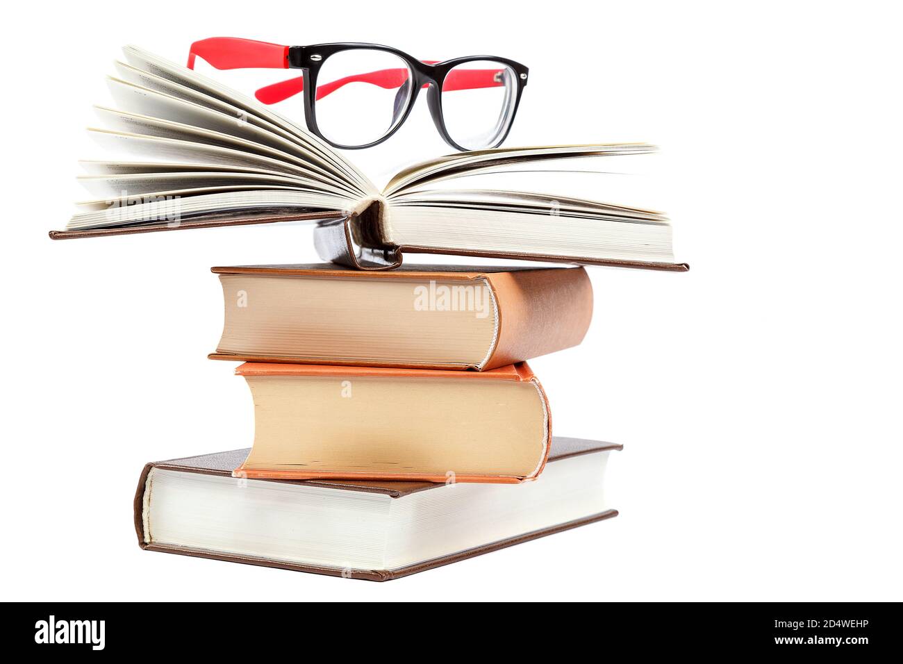 Open book and glasses on a stack of books isolated on white background ...