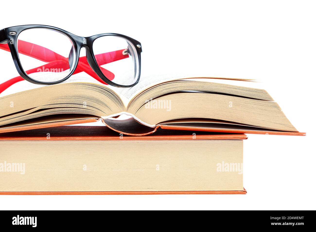 Open book and glasses on a stack of books isolated on white background ...