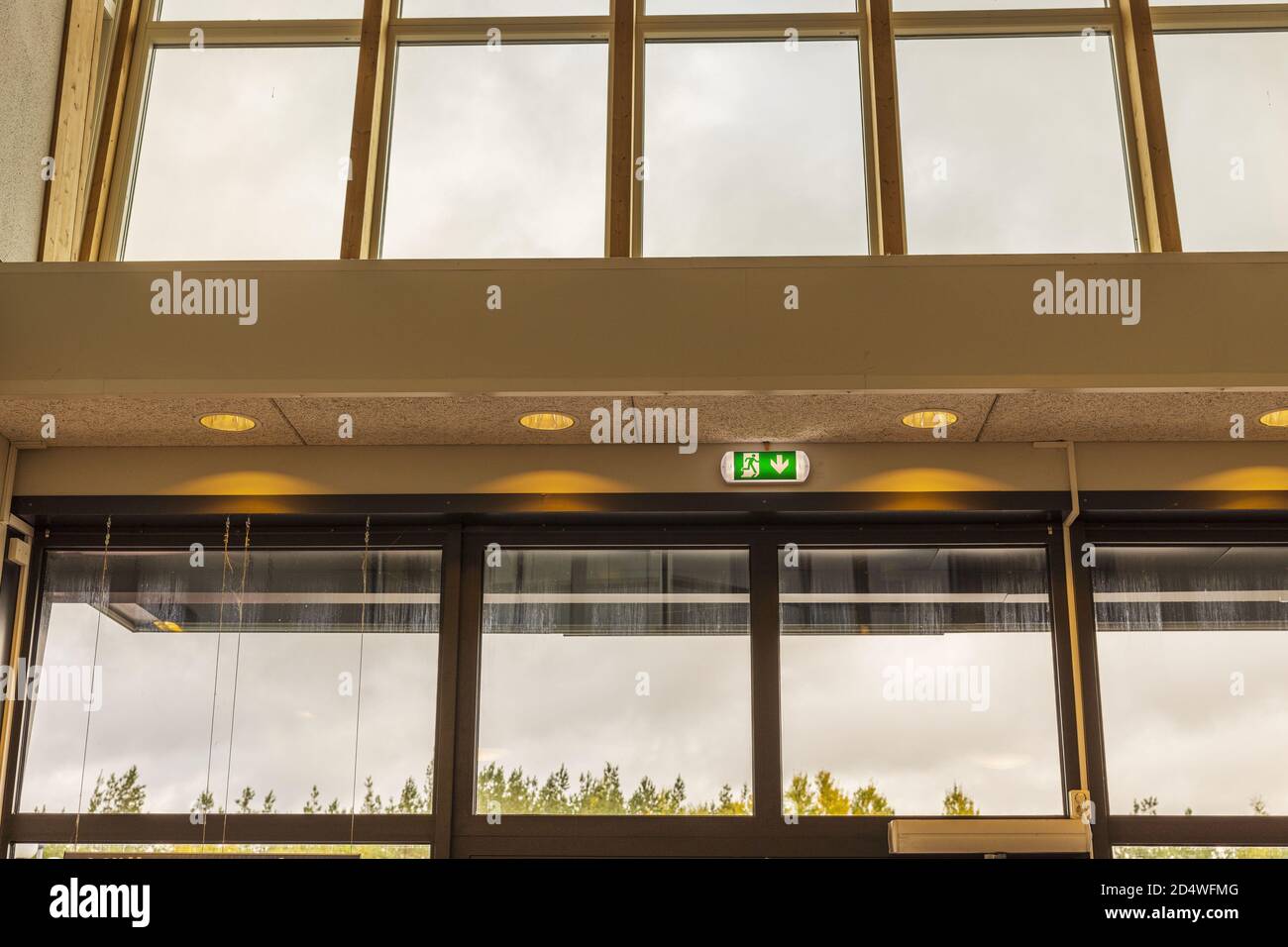 Close up view of green white wall and ceiling light, emergency exit ...