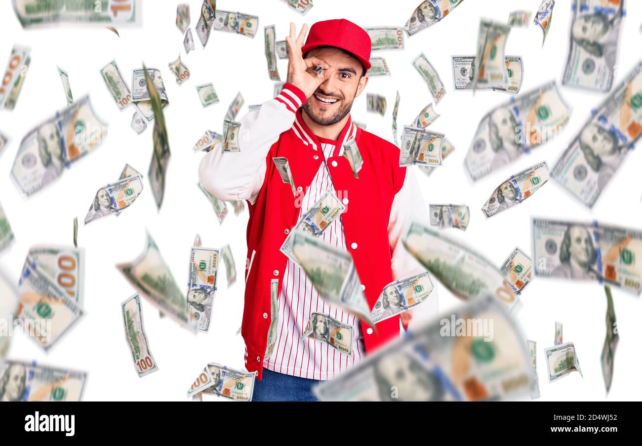 Young handsome man wearing baseball jacket and cap smiling happy doing ...