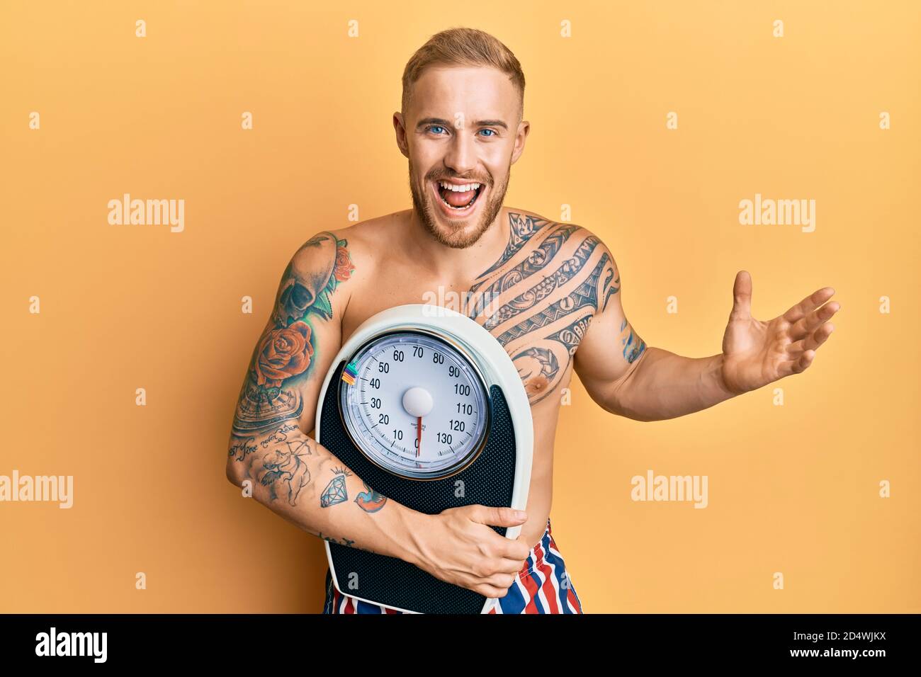 Young caucasian man holding weight machine to balance weight loss ...