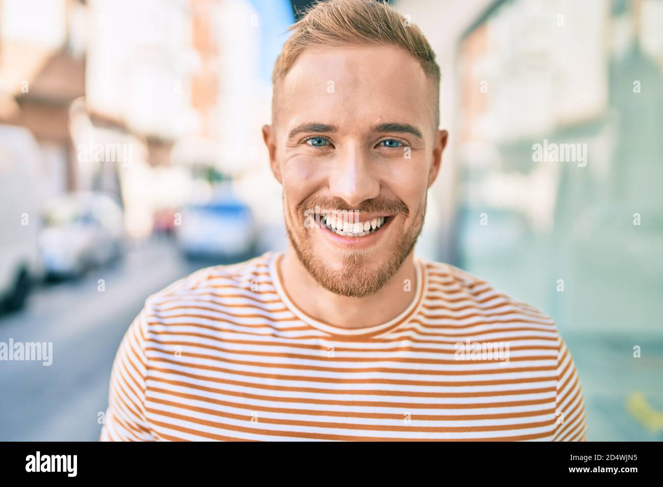 Young irish man smiling happy walking at street of city Stock Photo - Alamy
