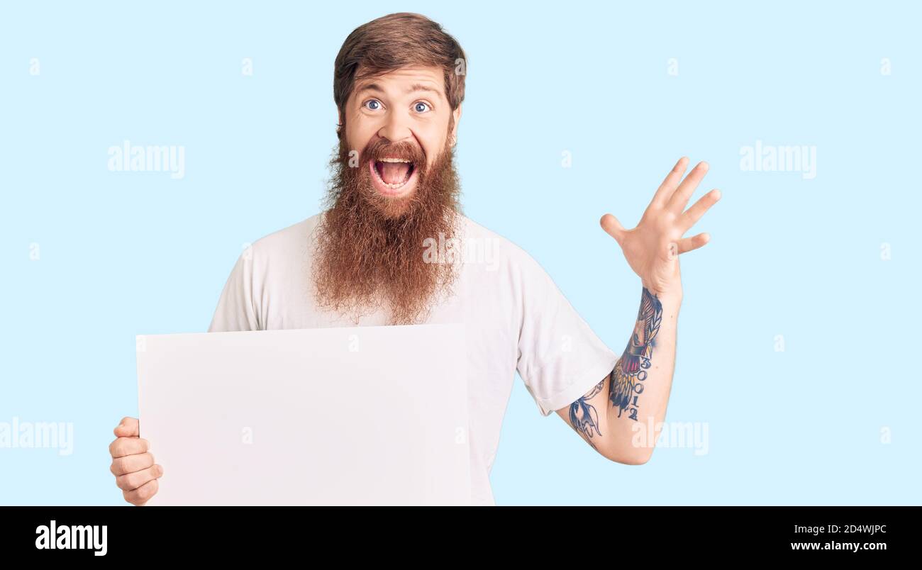 Handsome Young Red Head Man With Long Beard Holding Blank Empty Banner