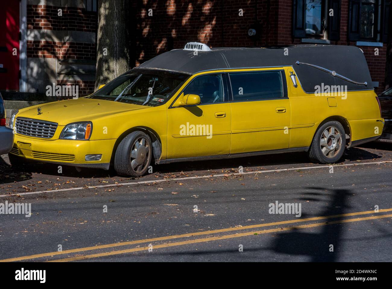 Hearse adapted to look like yellow taxi, w/nowhere sign Stock Photo - Alamy