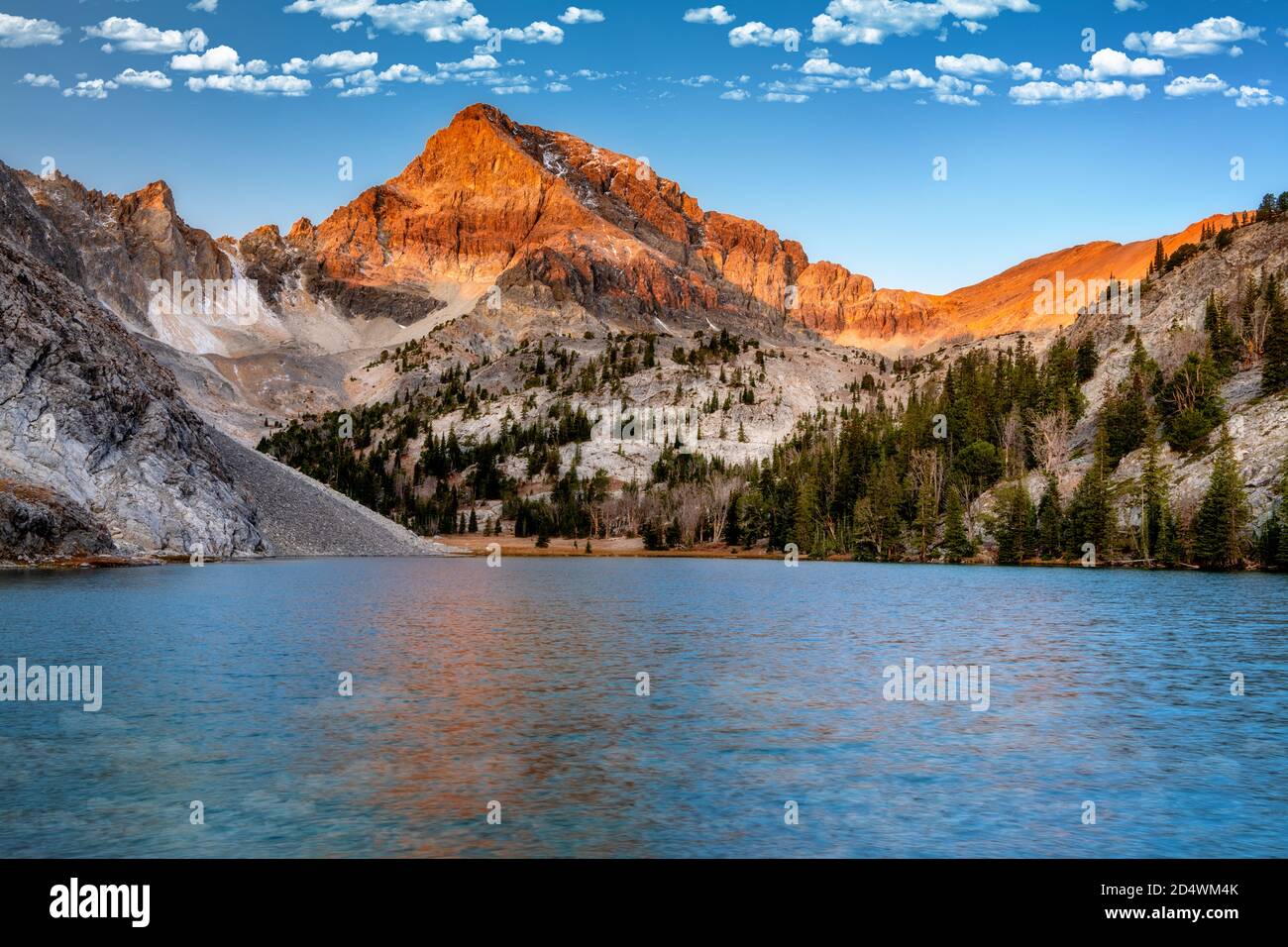 Warm colors paint the top of Mount Idaho at a mountain lake Stock Photo ...