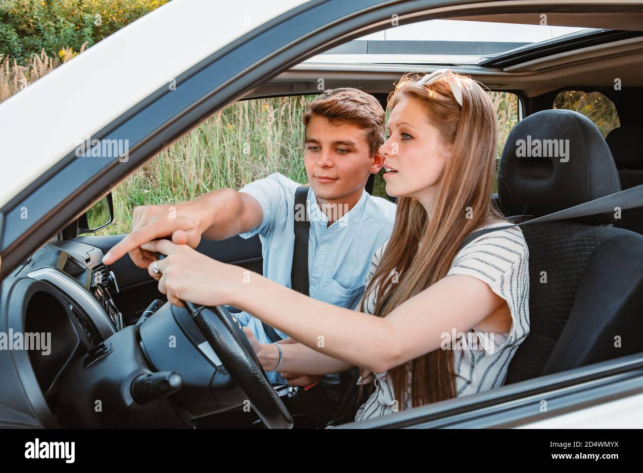 young woman with man in car. summer road trip Stock Photo - Alamy