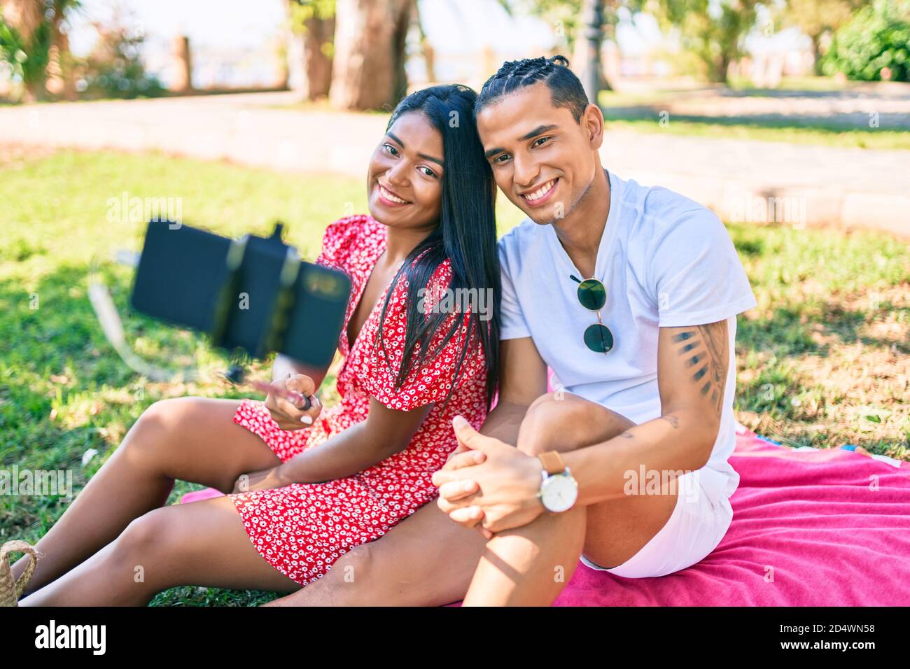 Young latin couple smiling happy make selfie by the smartphone sitting ...