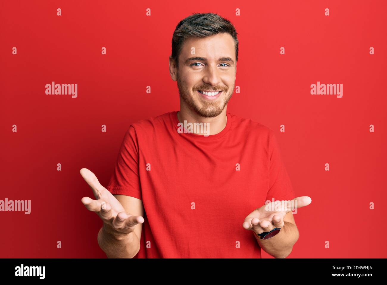 Handsome caucasian man wearing casual red tshirt smiling cheerful with ...